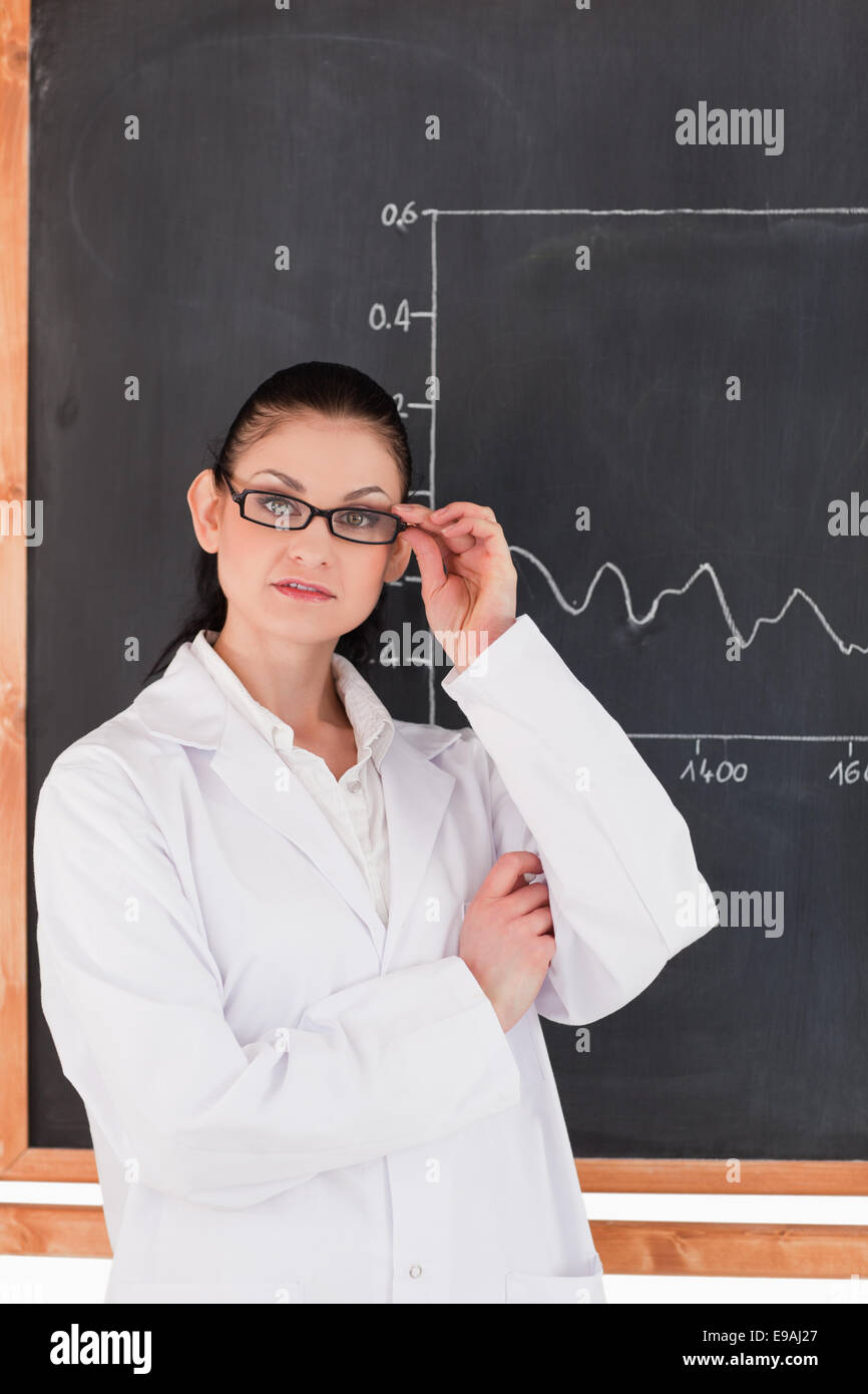 Female scientist standing near the blackboard Stock Photo - Alamy