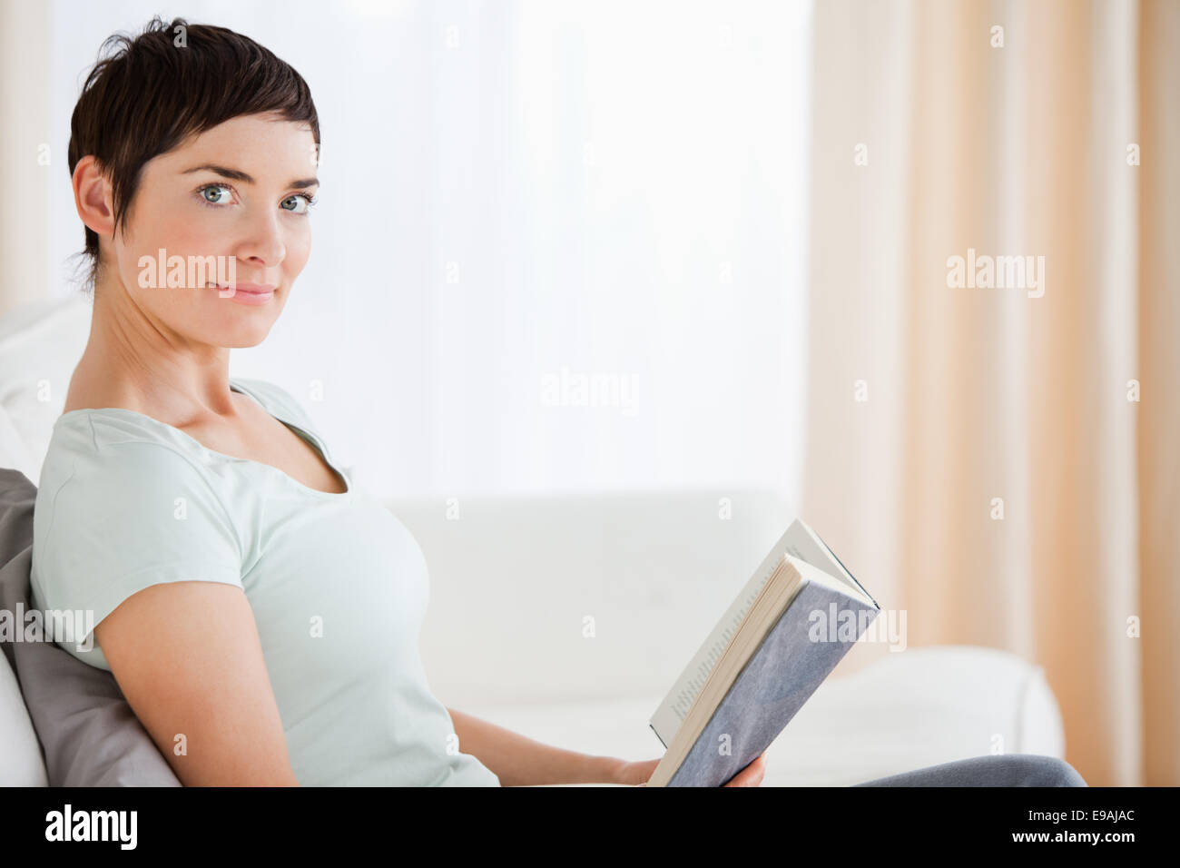 Short-haired woman holding a book Stock Photo - Alamy