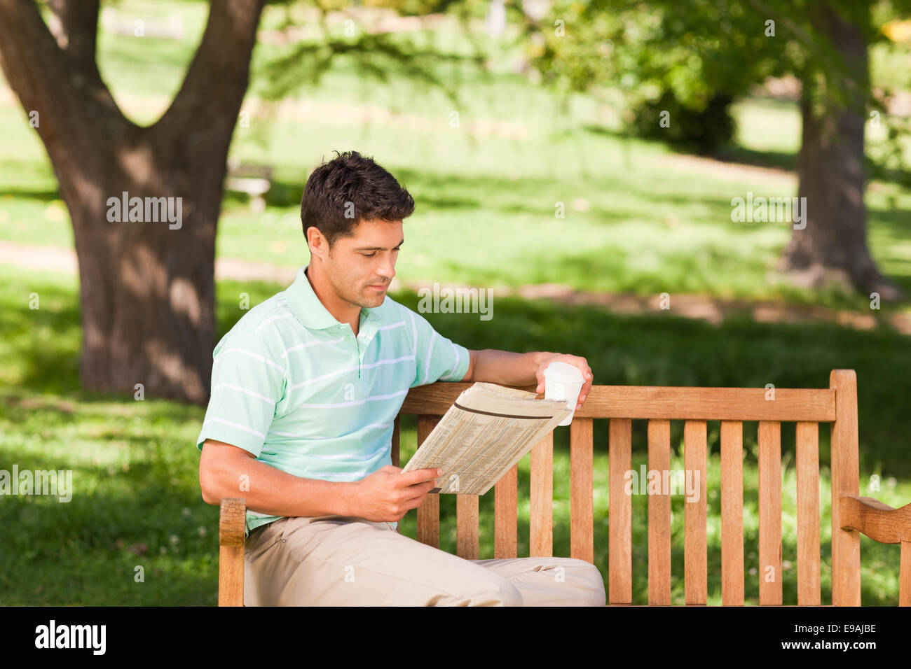 Man reading the newspaper Stock Photo - Alamy