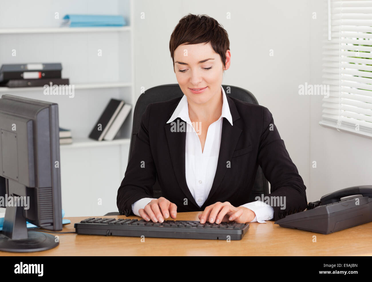 Secretary typing on her keybord Stock Photo - Alamy