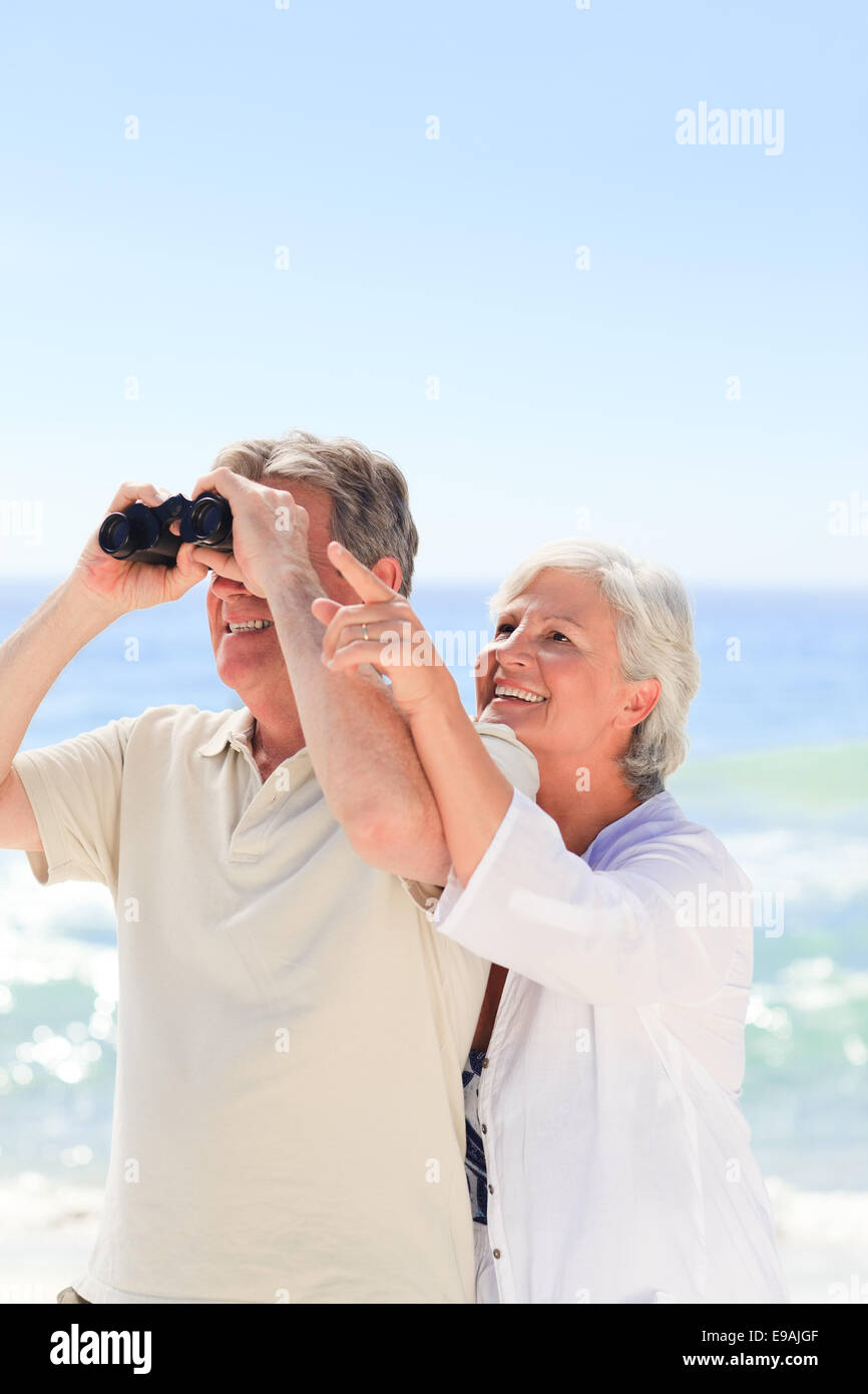 Senior couple bird watching at the beach Stock Photo - Alamy