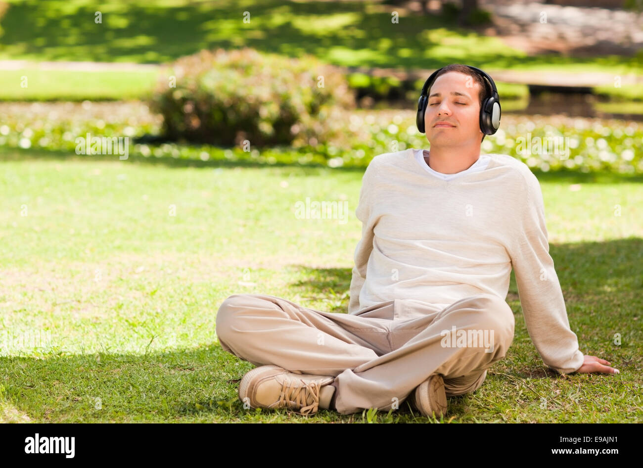 Man listening to music in the park Stock Photo - Alamy