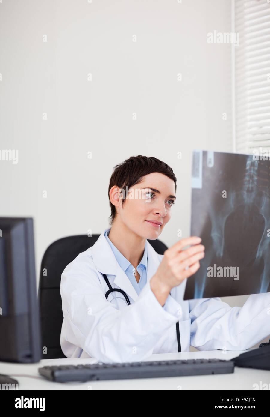 Focused female doctor looking at X-ray Stock Photo - Alamy