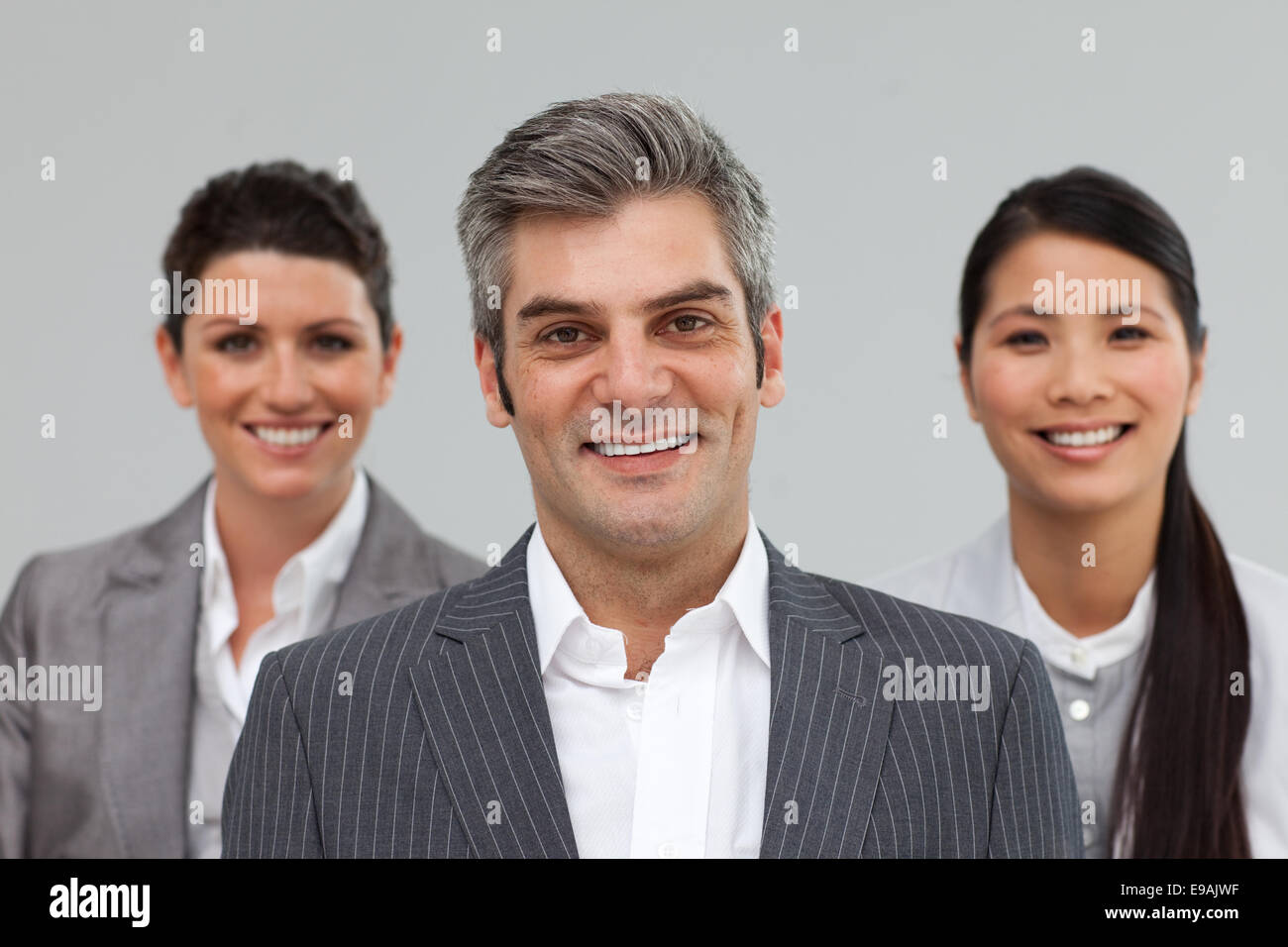 Smiling Business partners standing together Stock Photo - Alamy