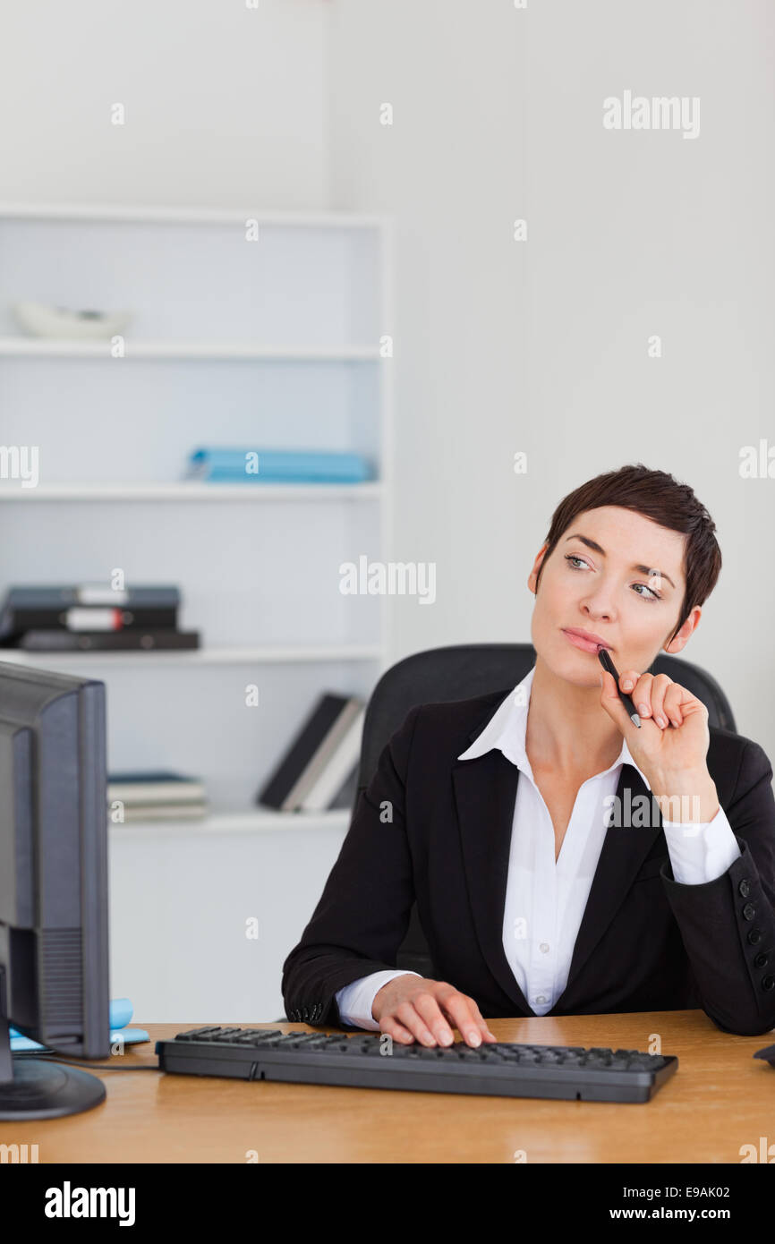 Portrait of a secretary thinking Stock Photo - Alamy