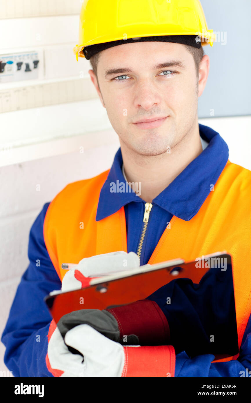 Happy electrician repairing a power plan Stock Photo - Alamy
