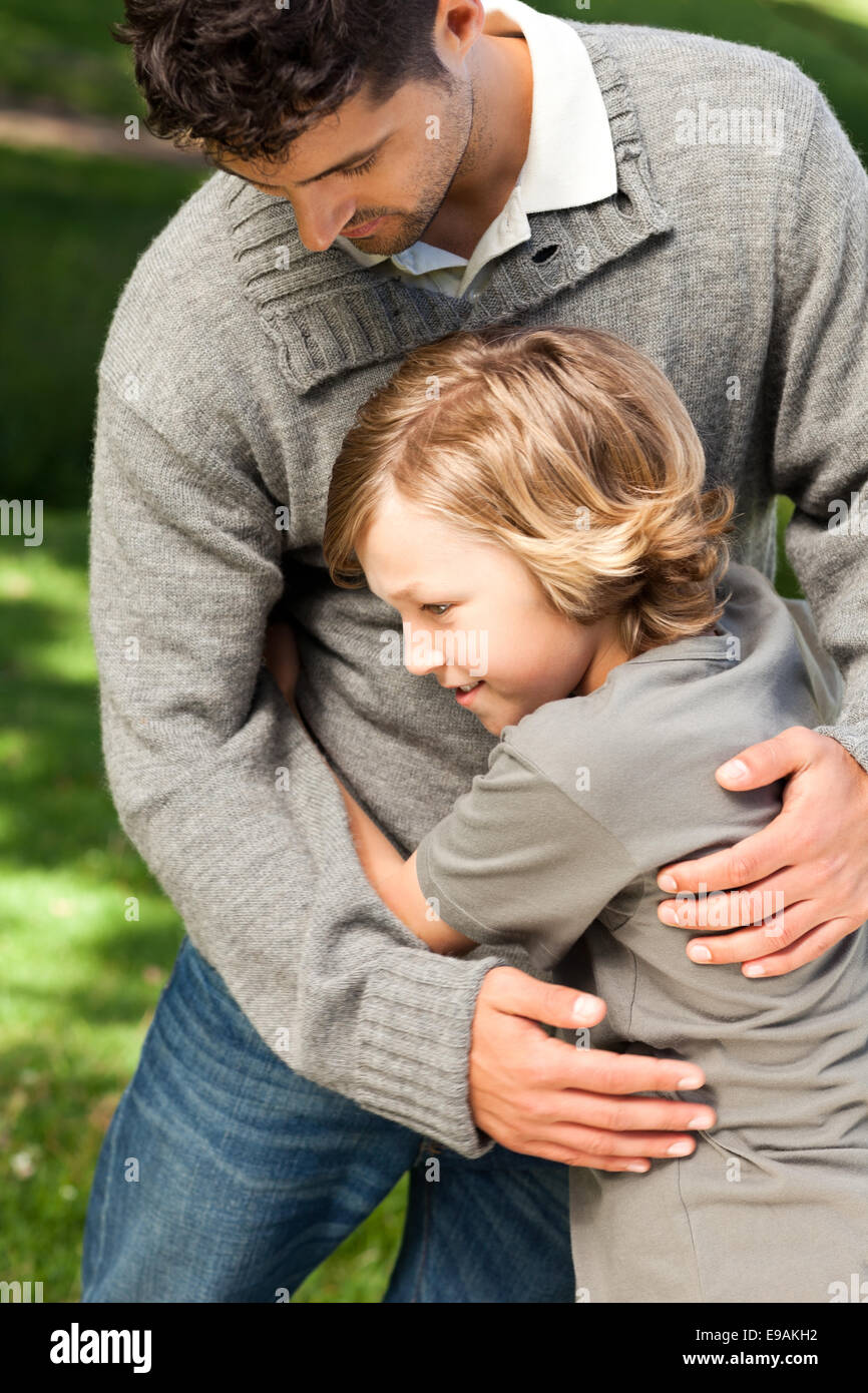Son embracing his father Stock Photo - Alamy