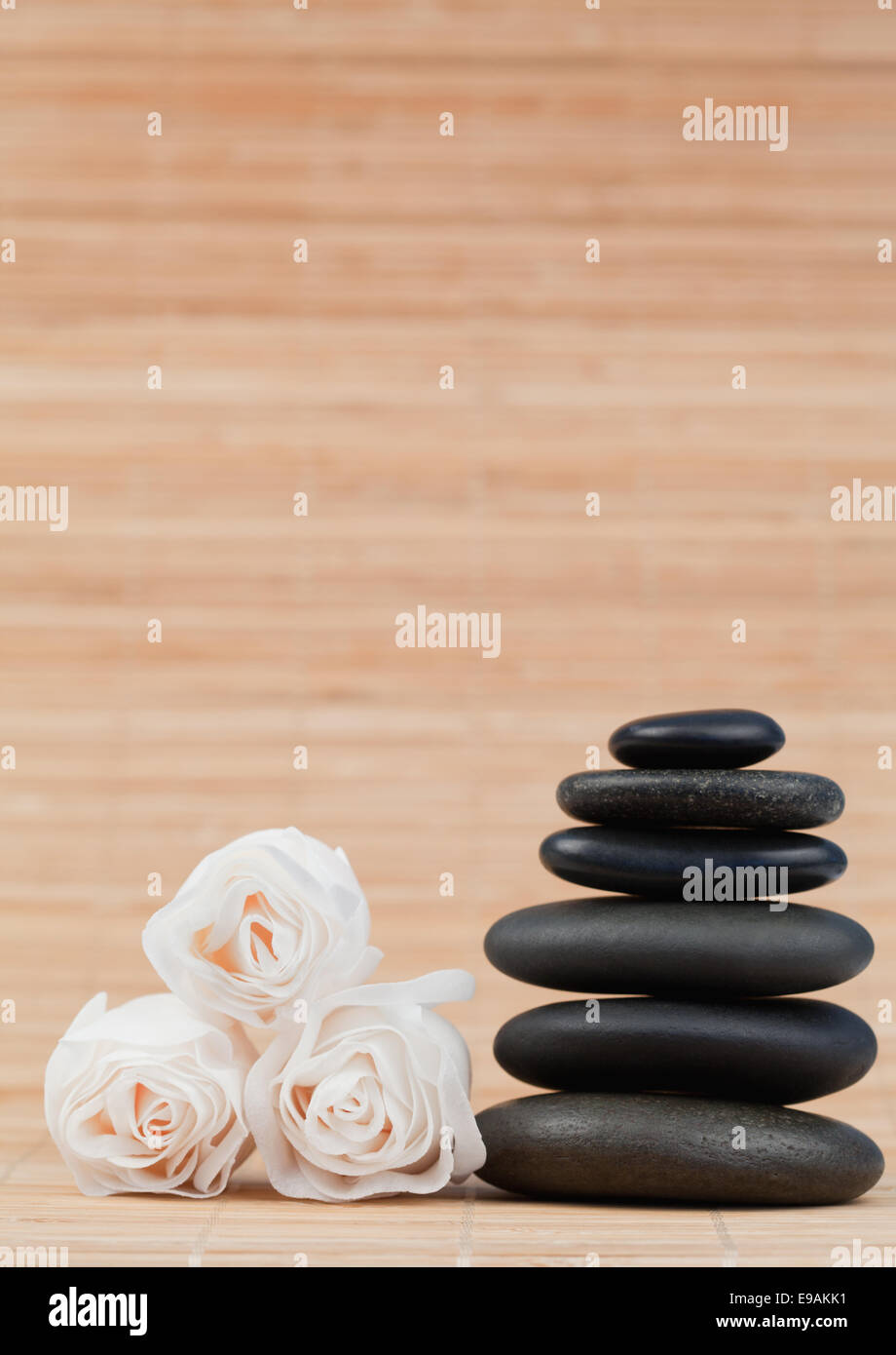 Roses and a black pebbles stack Stock Photo - Alamy