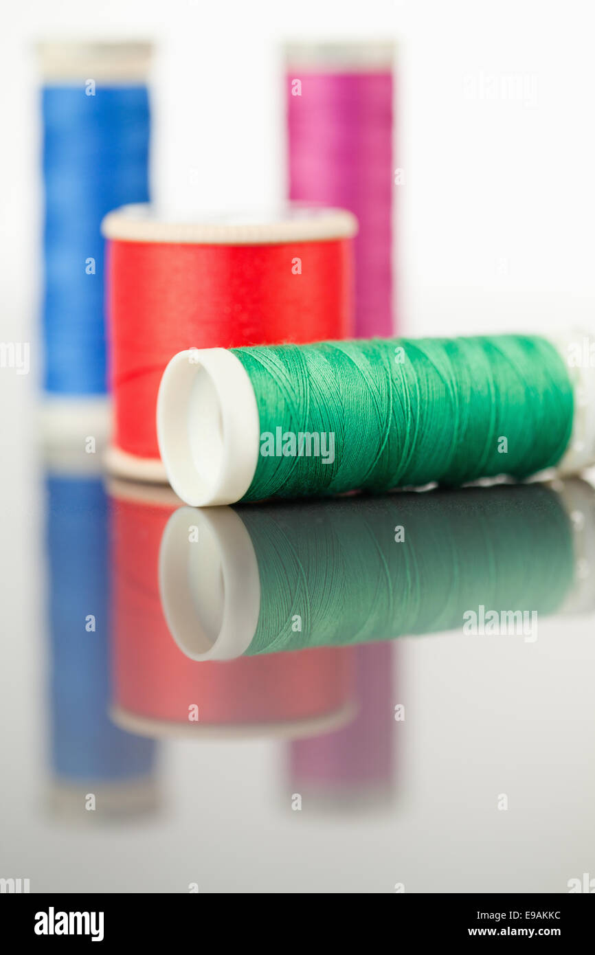 Colorful spools of thread on a table Stock Photo - Alamy