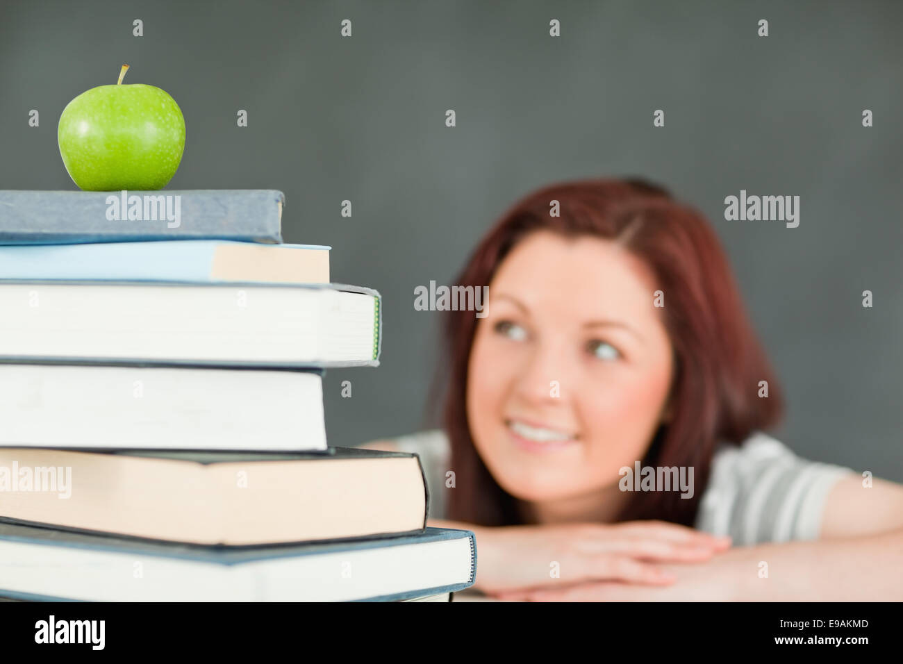 Young female student with a stack of books Stock Photo - Alamy