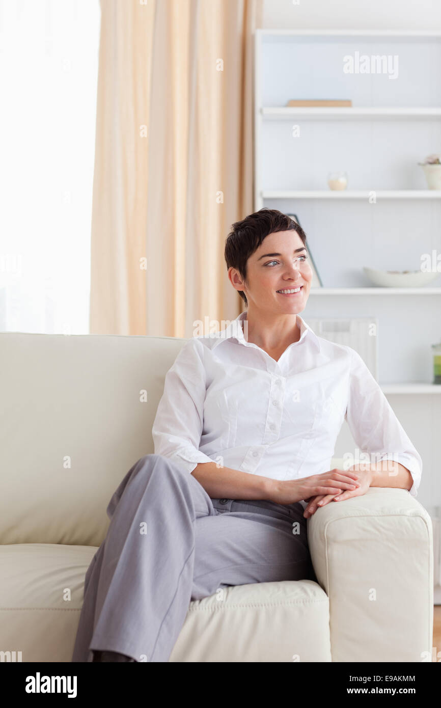 Cute woman sitting on a sofa Stock Photo - Alamy
