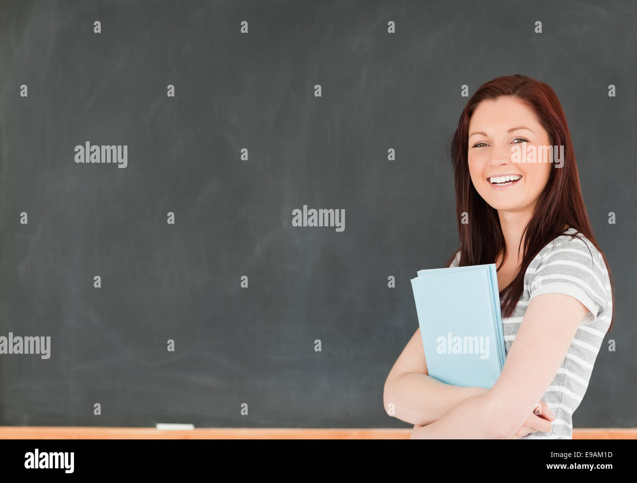 Young woman holding her notes Stock Photo - Alamy