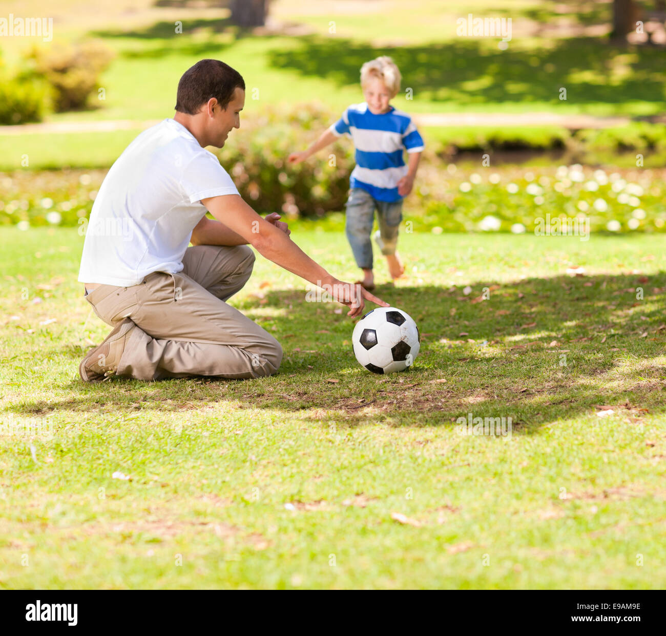 Father playing football with his son Stock Photo - Alamy