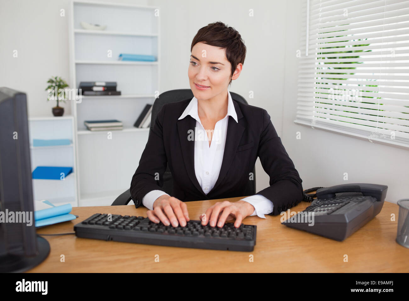 Cheerful female secretary typing hi-res stock photography and images ...