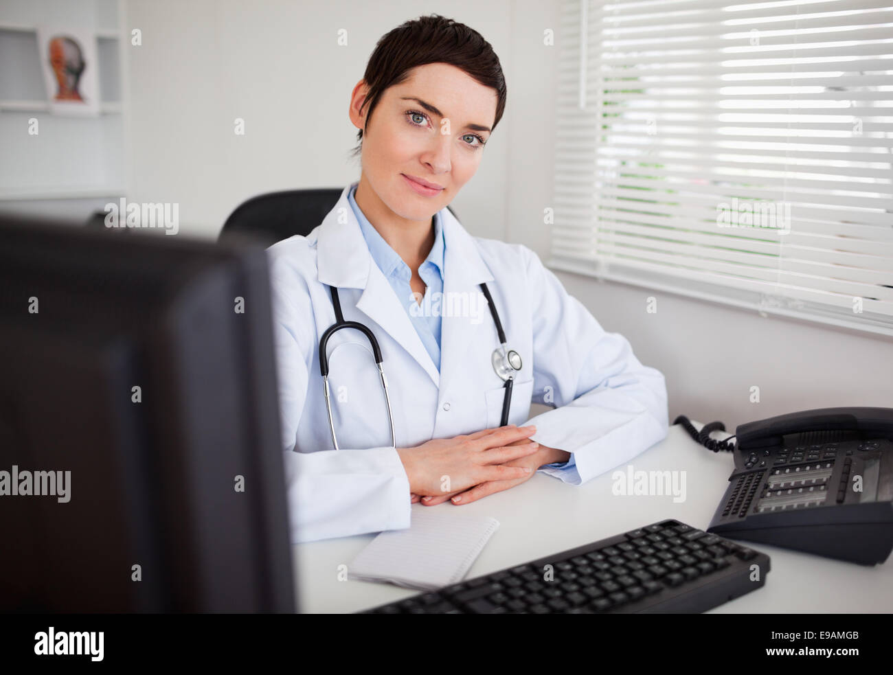 Serious female doctor looking at the camera Stock Photo - Alamy