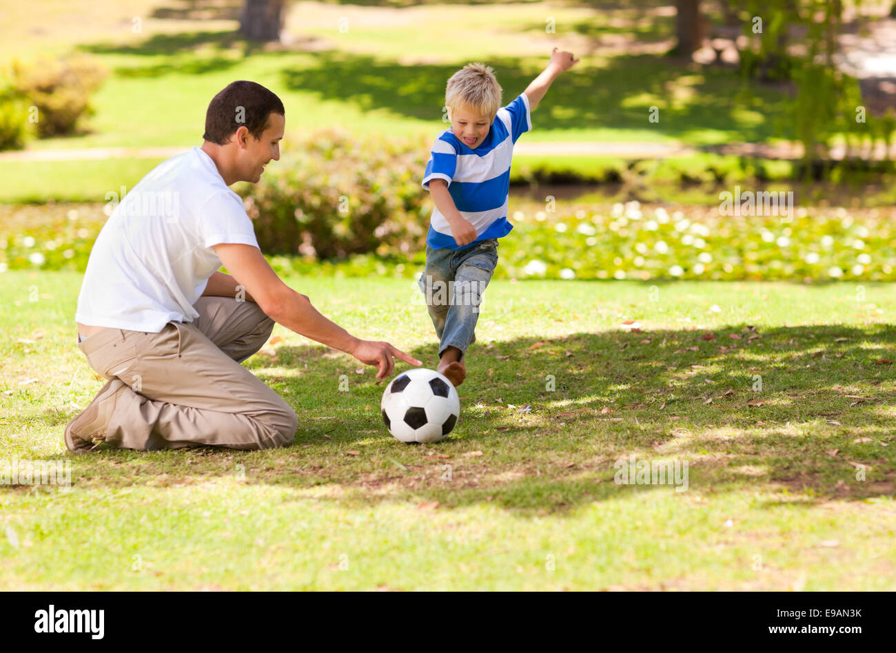 Father playing football with his son Stock Photo - Alamy