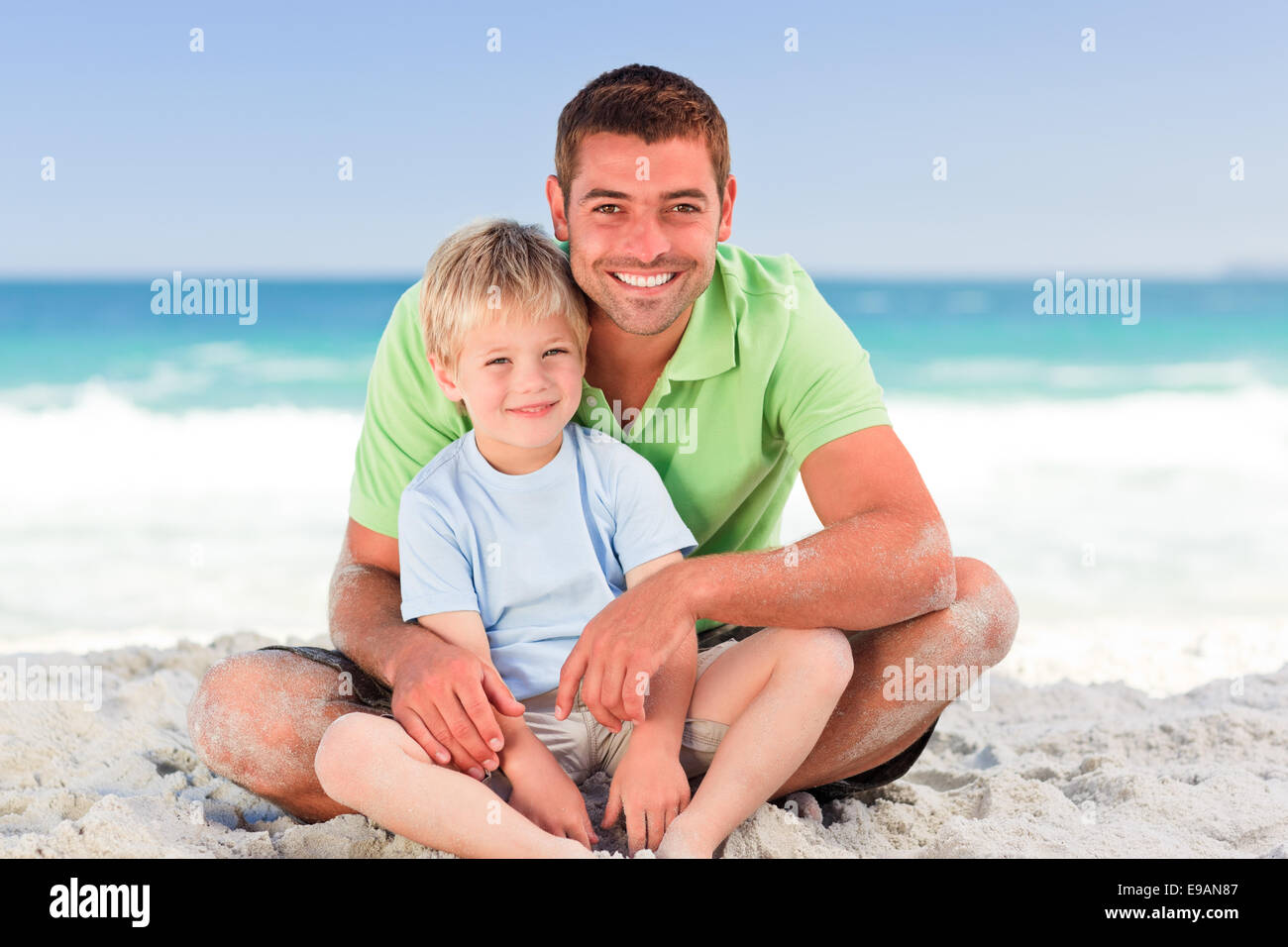 Attentive father with his son at the beach Stock Photo - Alamy