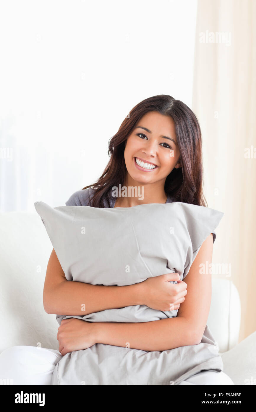 smiling woman with pillow in her arms Stock Photo - Alamy