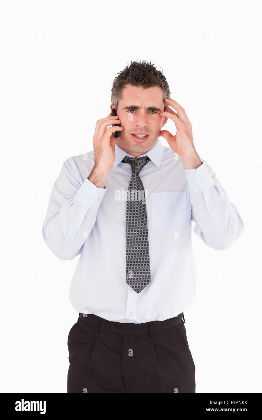 Portrait of a sad man making a phone call Stock Photo - Alamy