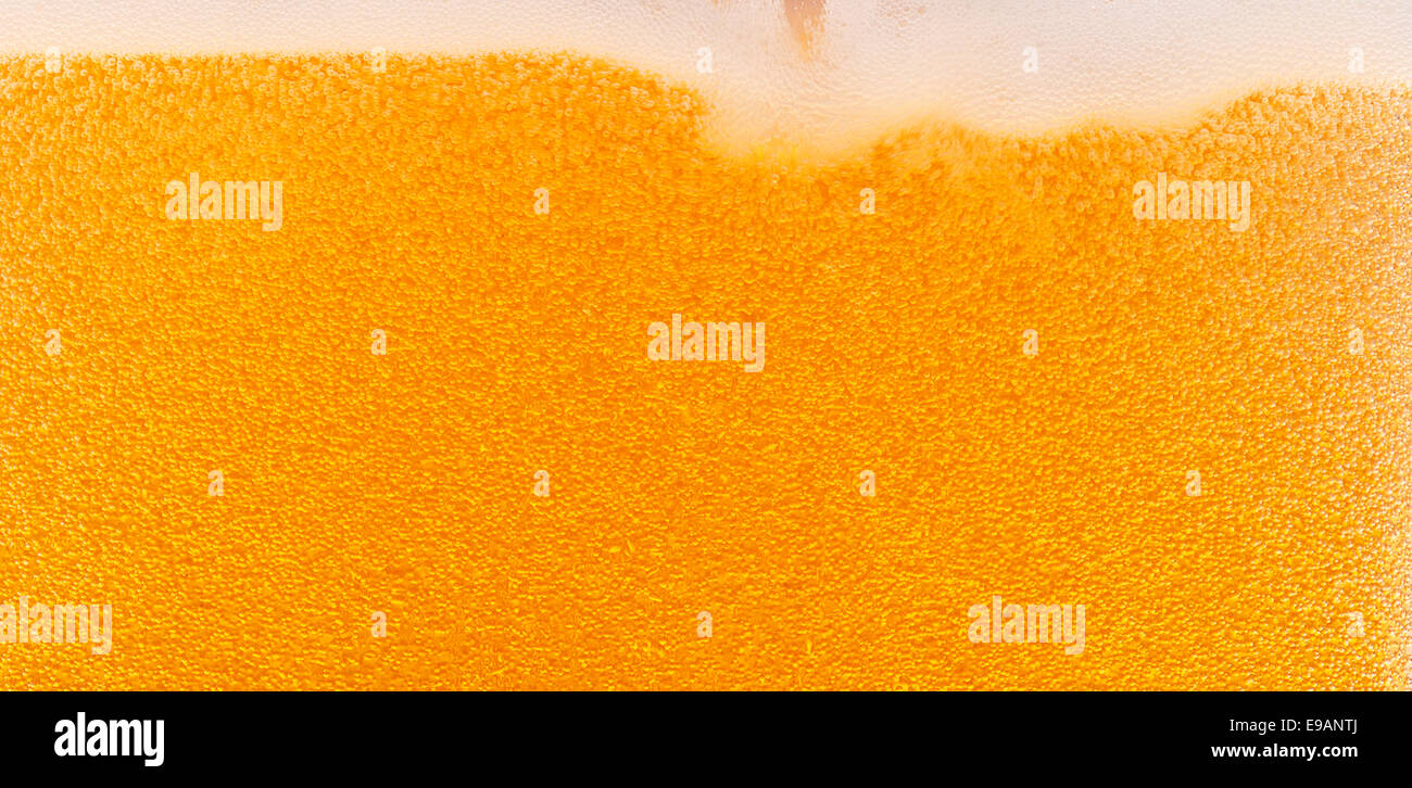 Close-up of golden bubbles in beer Stock Photo - Alamy