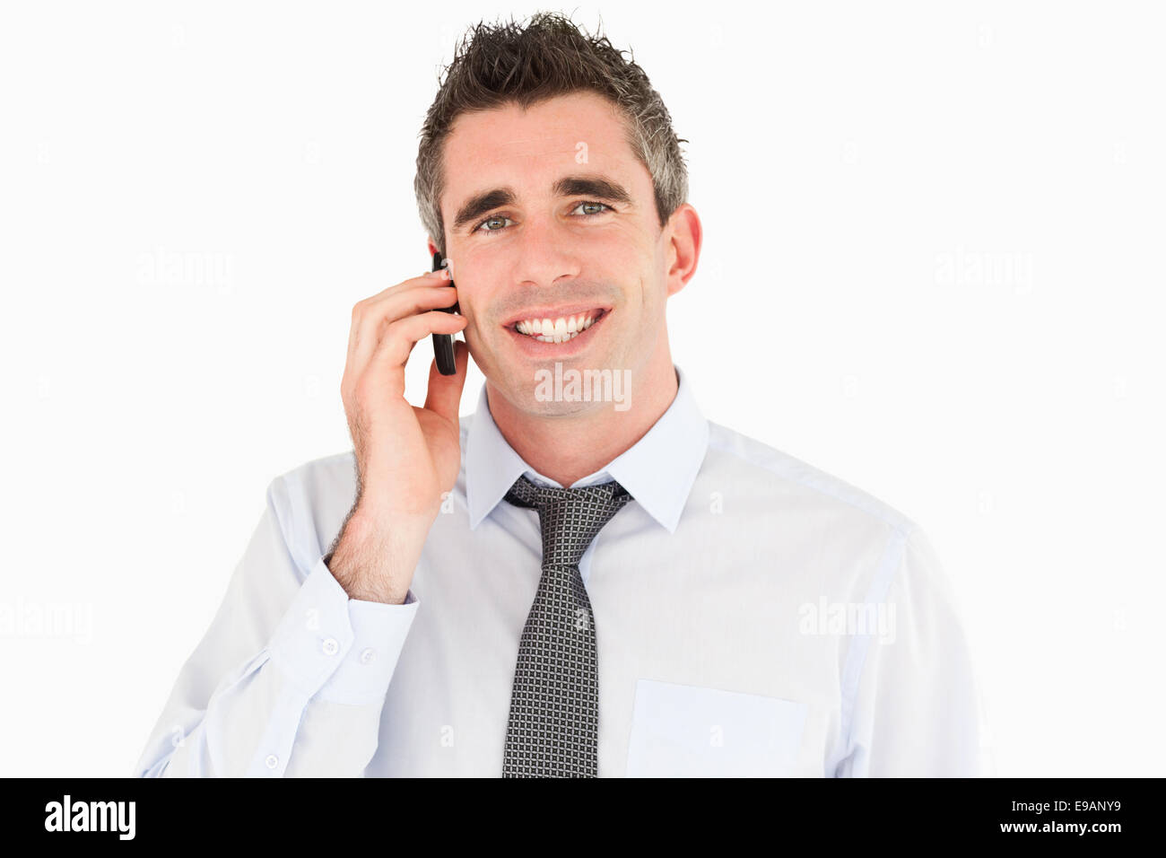 Smiling man making a phone call Stock Photo - Alamy
