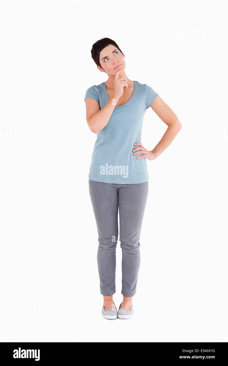 Thoughtful woman standing up Stock Photo - Alamy