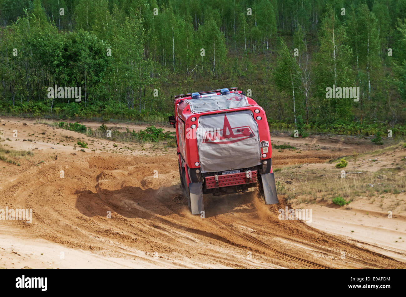 Races on a rally-raid on sandy dunes. Racing truck maz number 302 Stock ...
