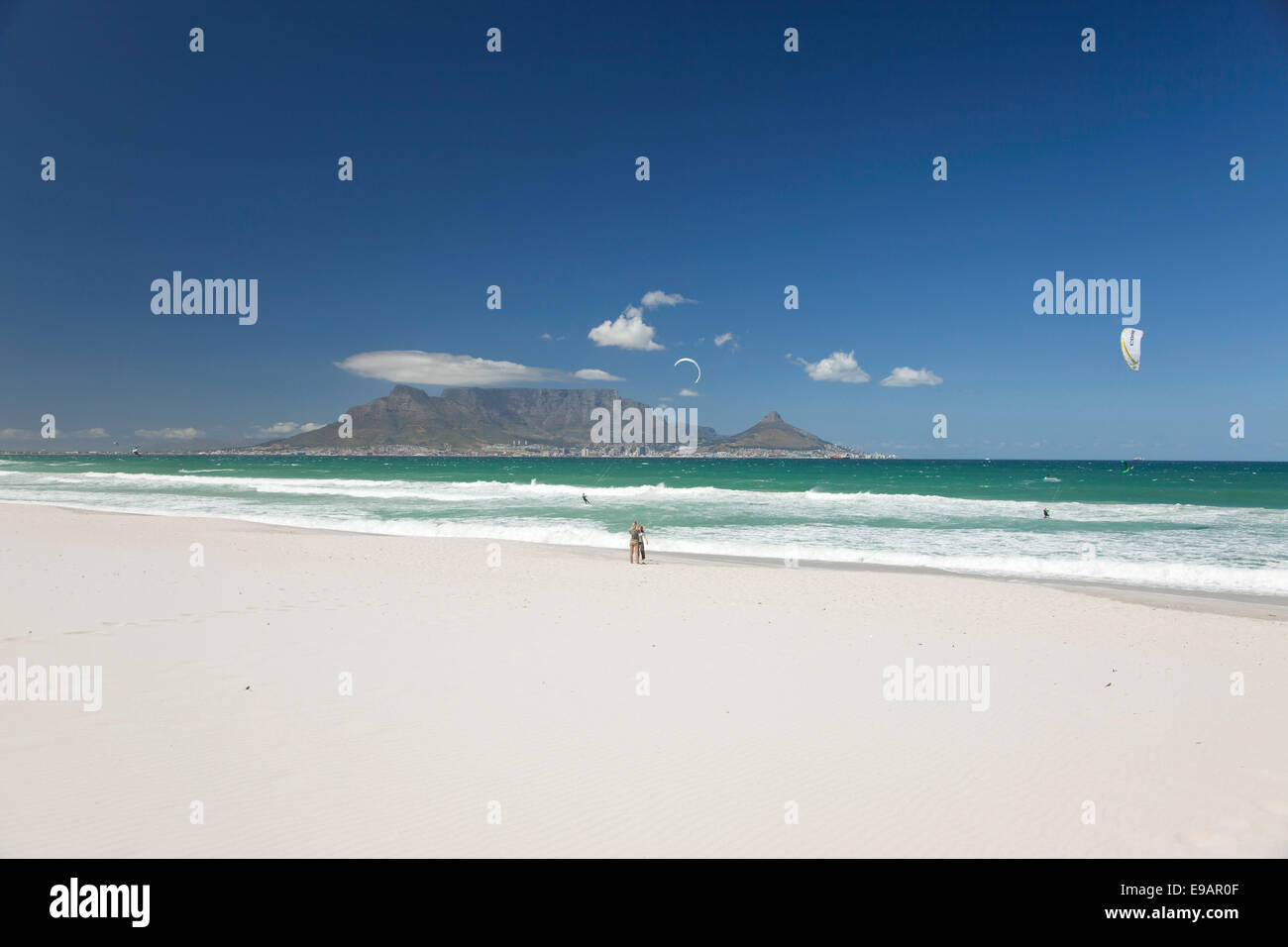 kitesurfer at Bloubergstrand beach with view to Cape Town and the table ...