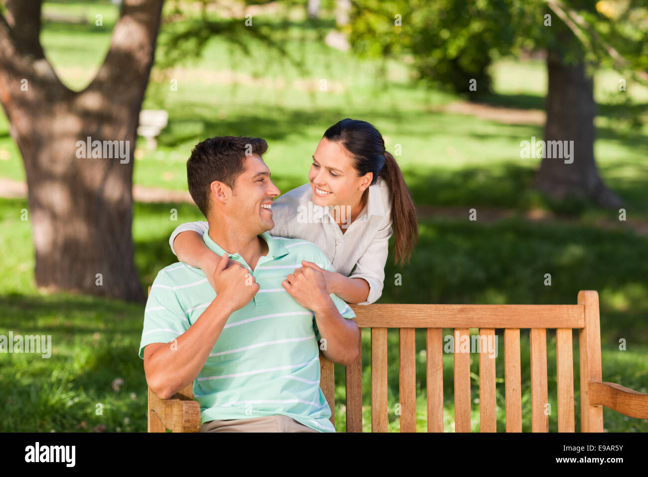 Woman huging her boyfriend Stock Photo - Alamy