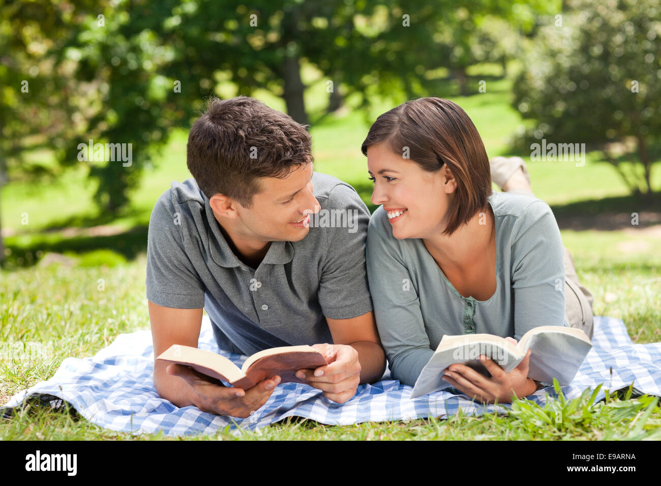 Couple reading a book Stock Photo - Alamy
