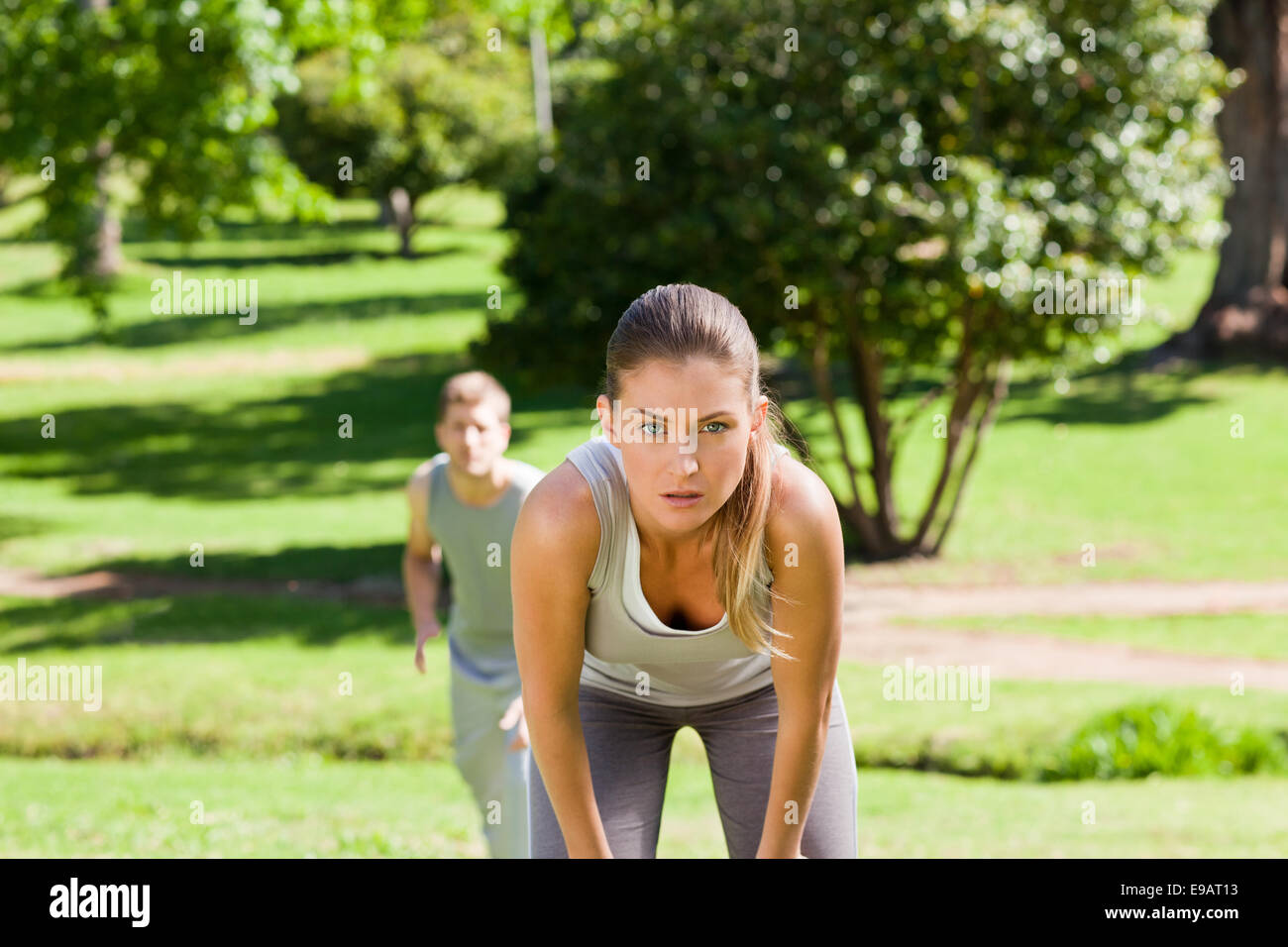 Exhausted couple in the park Stock Photo - Alamy