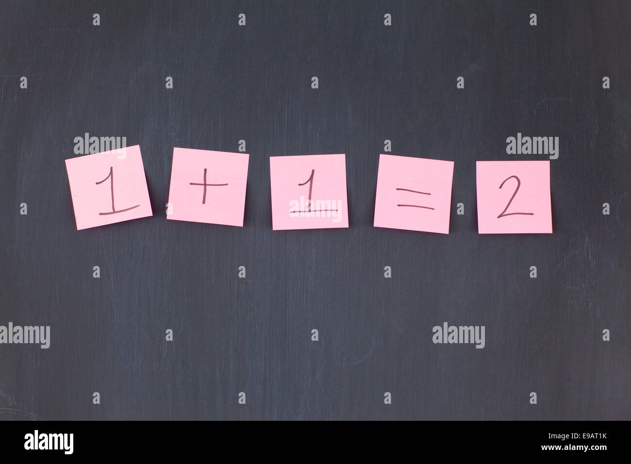 Pink sticky notes in a row on a blackboard Stock Photo - Alamy