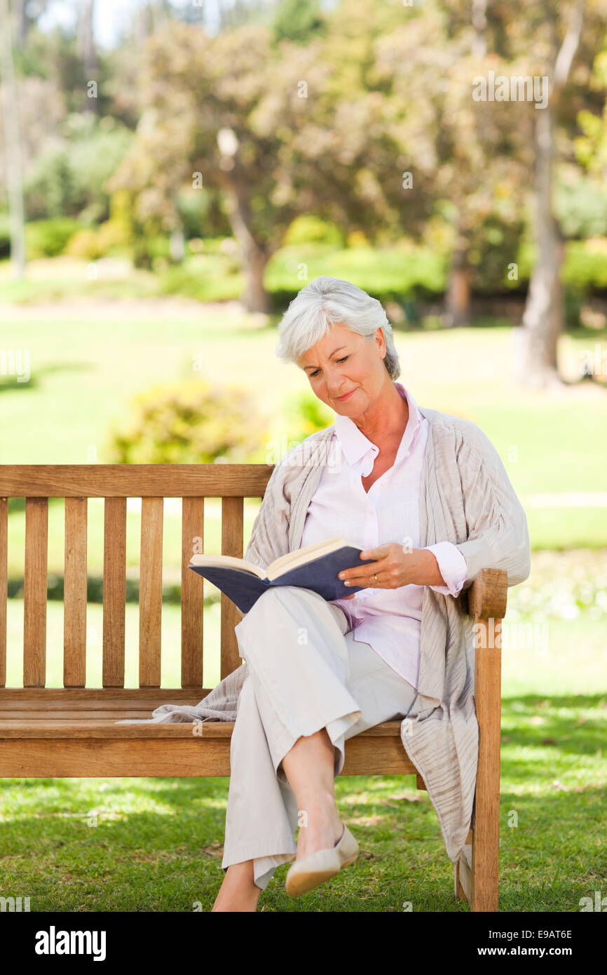 Retired woman reading a book Stock Photo - Alamy