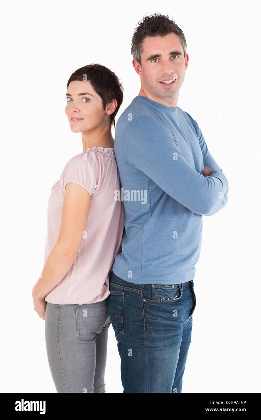 Back to back couple Stock Photo - Alamy