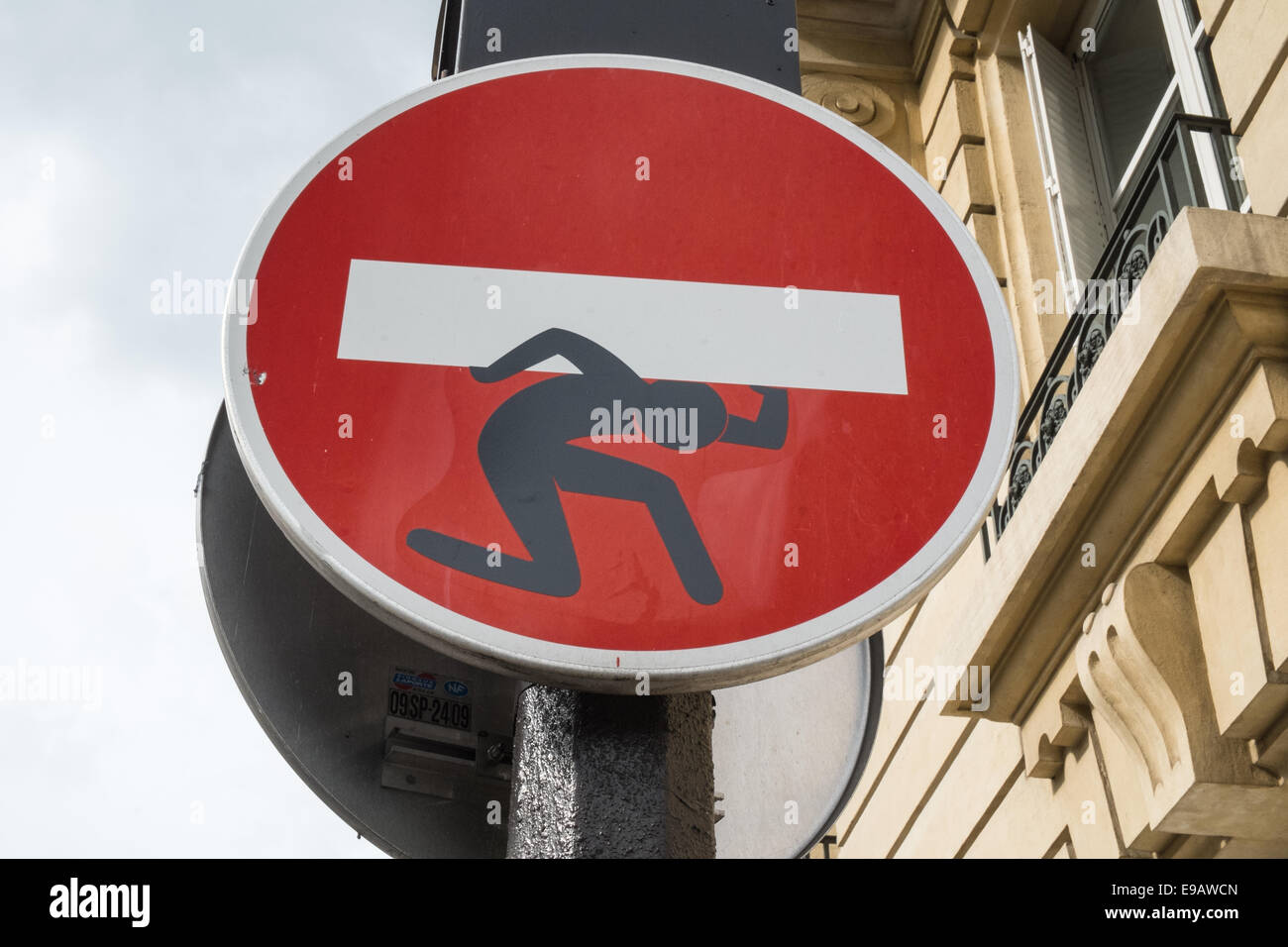 No entry road sign defaced in a humorous way to show a person carrying ...