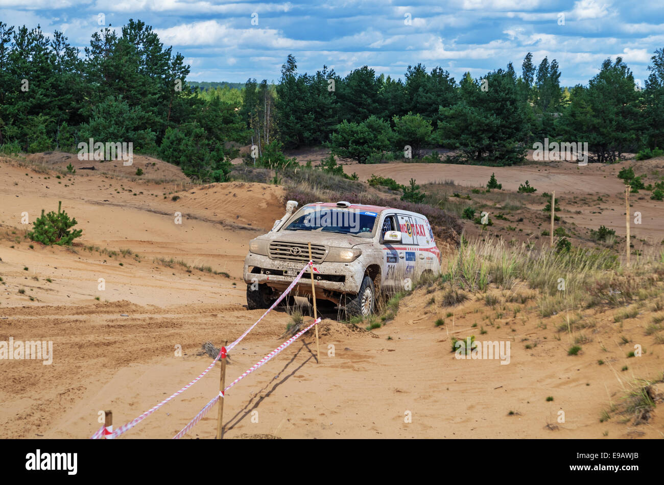 Races on a rally-raid on sandy dunes. Racing car number 211 Stock Photo ...