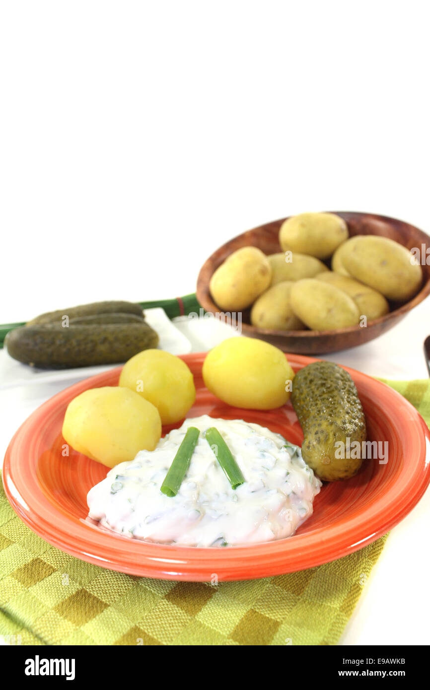 Potatoes with curd, pickles and chives on a light background Stock ...