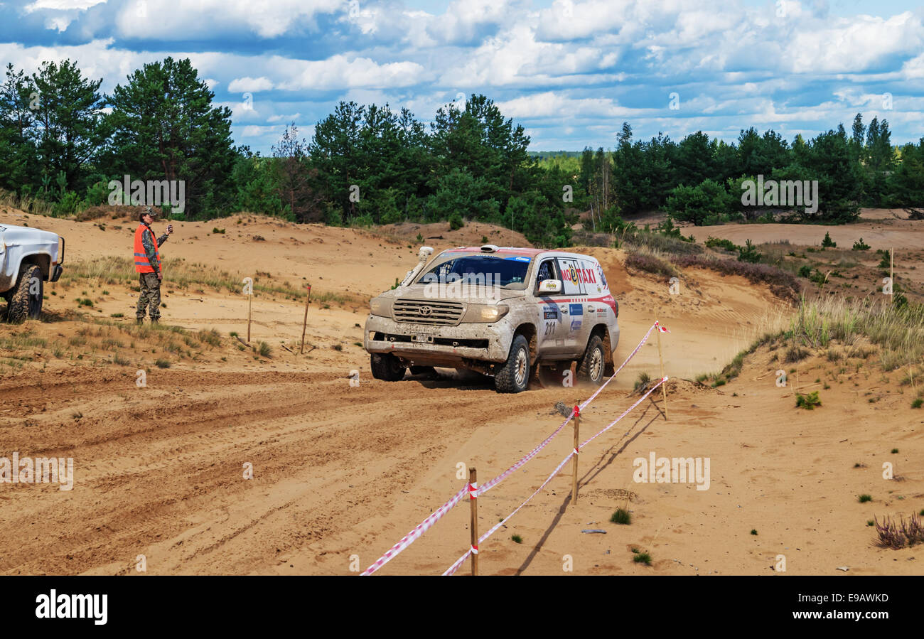 Races on a rally-raid on sandy dunes. Racing car number 211 Stock Photo ...