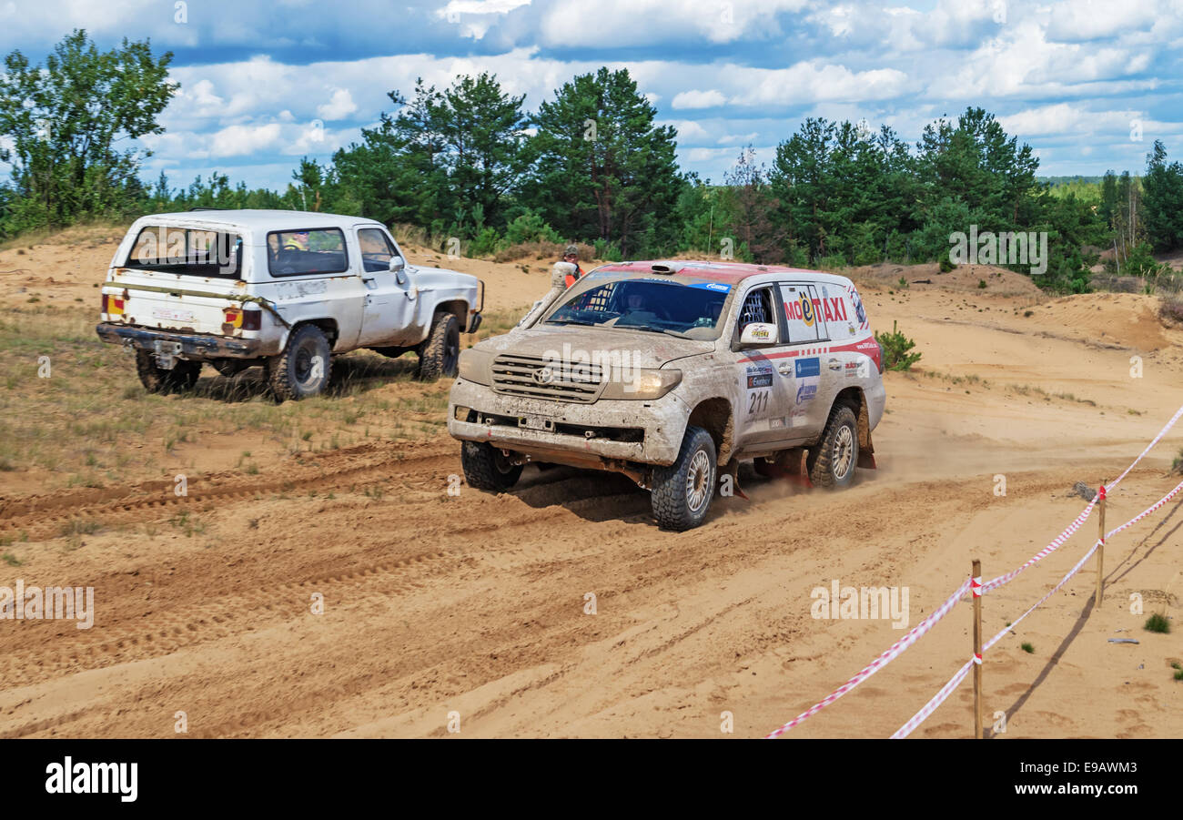 Races on a rally-raid on sandy dunes. Racing car number 211 Stock Photo ...
