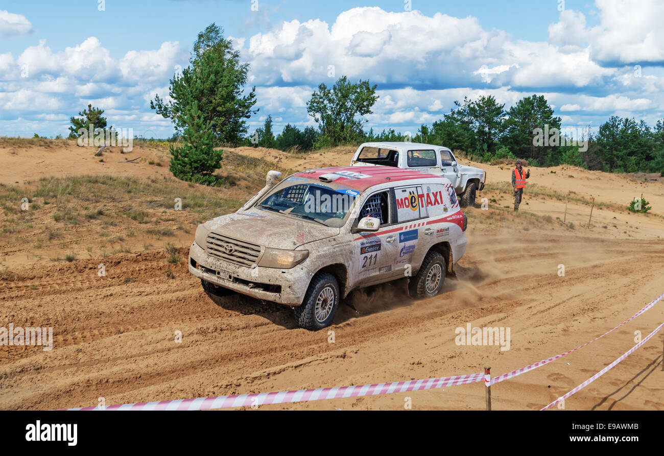 Races on a rally-raid on sandy dunes. Racing car number 211 Stock Photo ...
