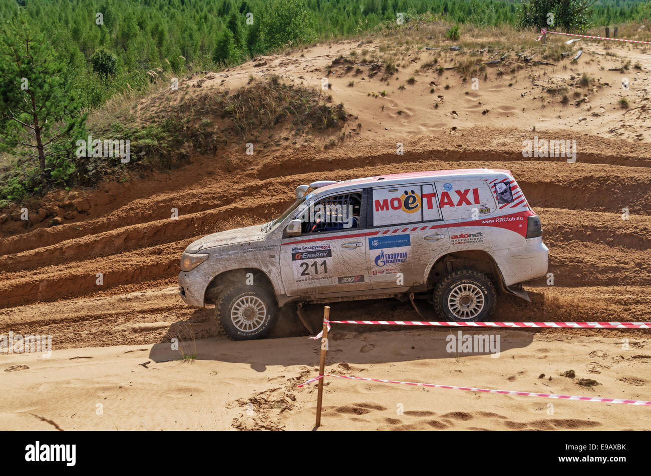 Races on a rally-raid on sandy dunes. Racing car number 211 Stock Photo ...