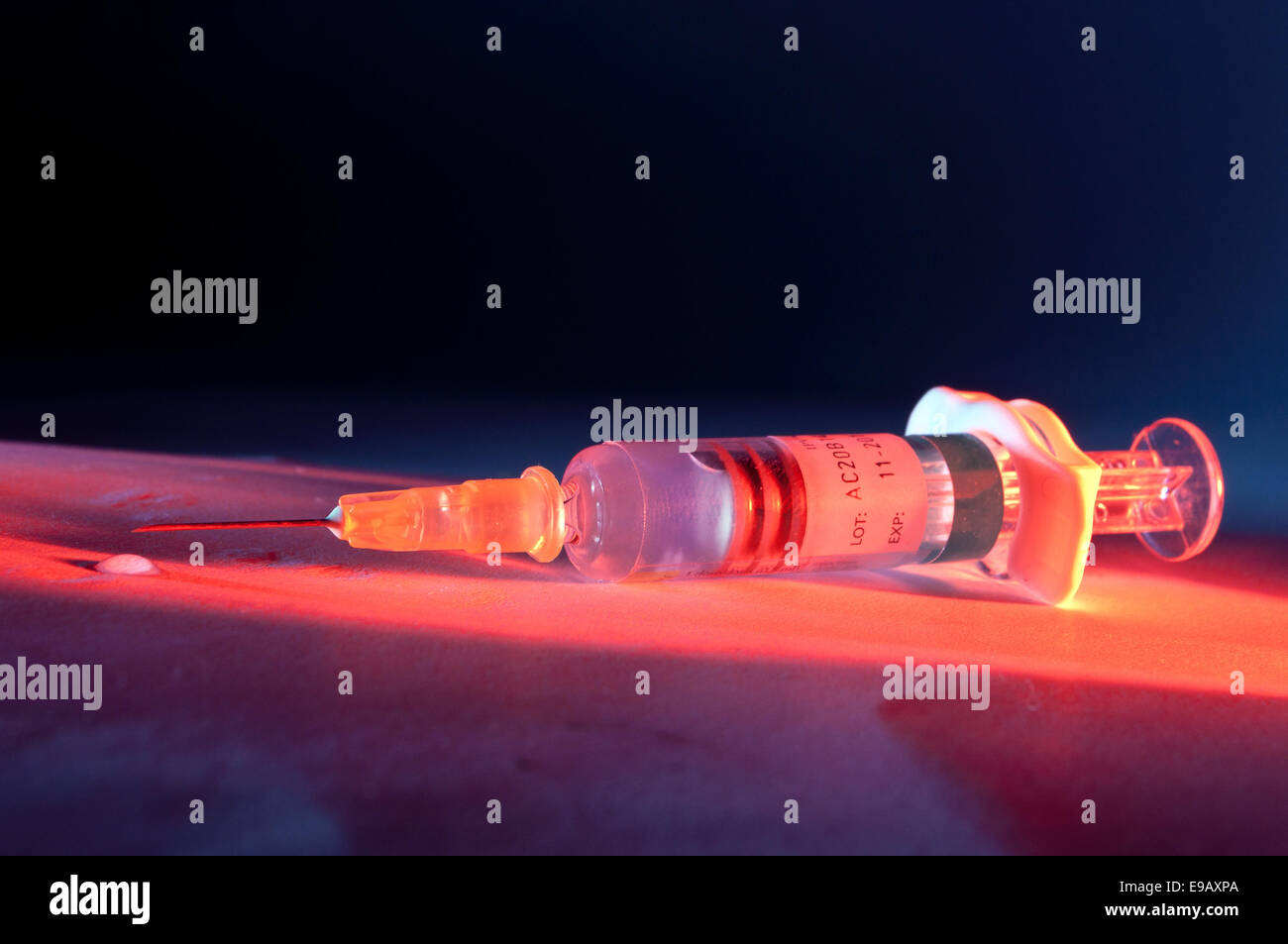 syringe lit by red light Stock Photo - Alamy