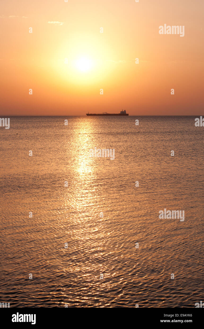 cargo ship in sunrise Stock Photo - Alamy