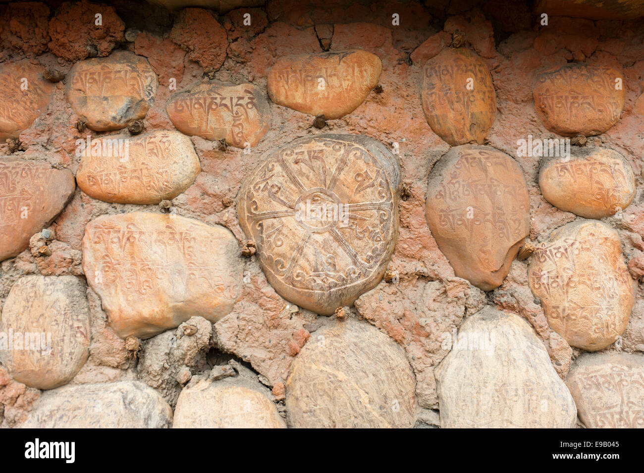 Mani stones with Tibetan inscriptions on wall, Buddhist Mani wall at ...
