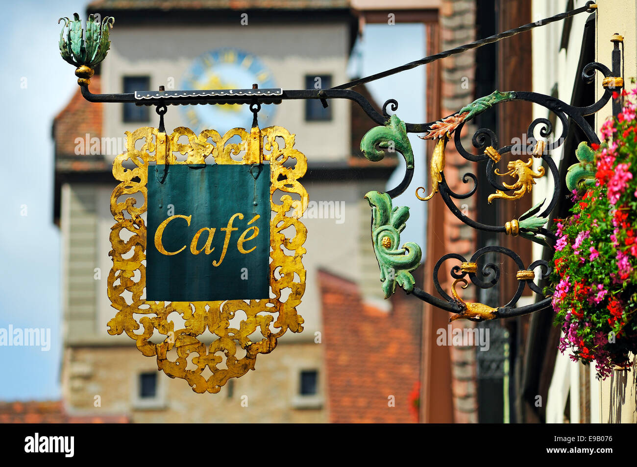 Hanging sign of a café, White Tower at back, Rothenburg ob der Tauber ...