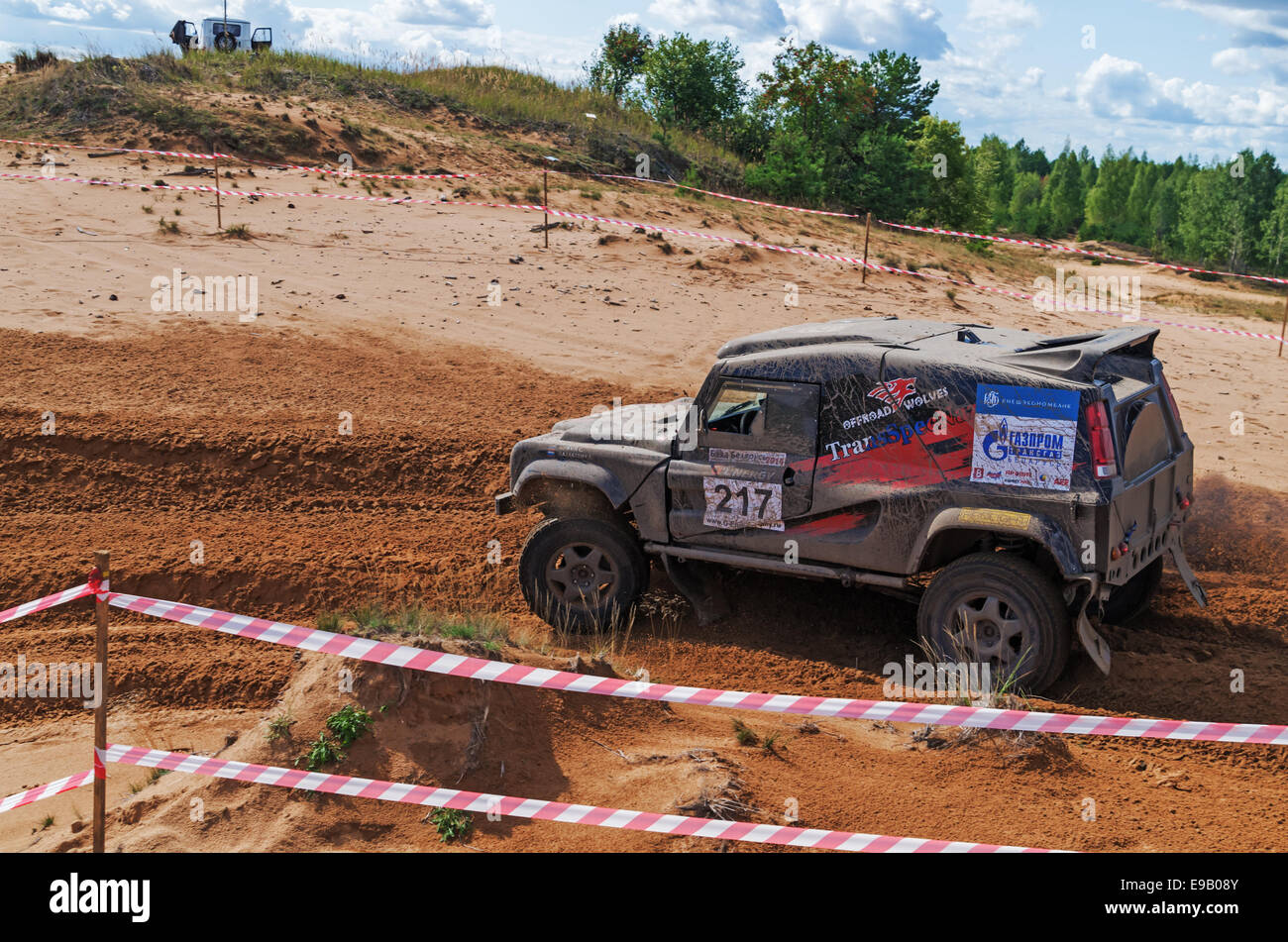 Races on a rally-raid on sandy dunes. Racing car number 217 Stock Photo ...