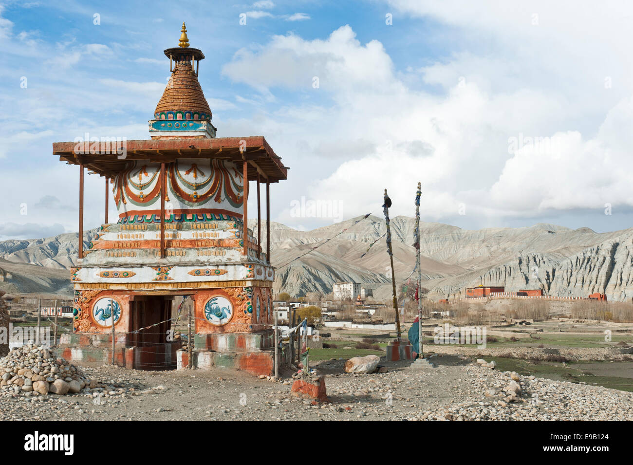 Colourfully decorated Buddhist stupa at the entrance to the village ...