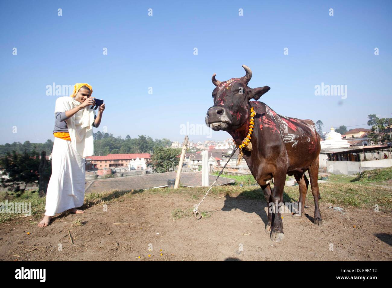 Kathmandu, Nepal. 23rd Oct, 2014. A Nepalese priest clicks a photo of a ...