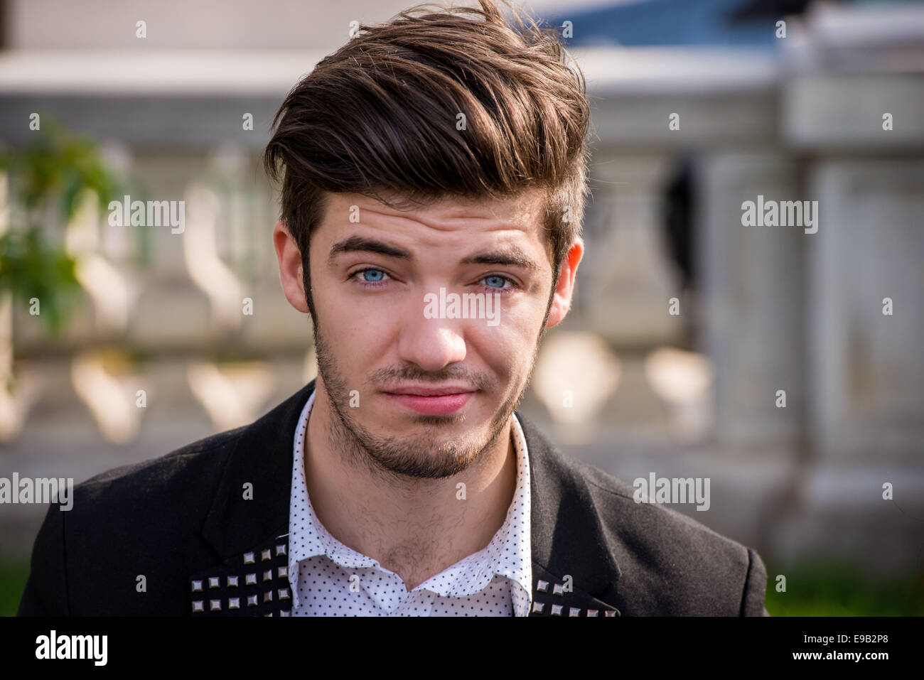Portrait of an attractive young man looking confused Stock Photo - Alamy