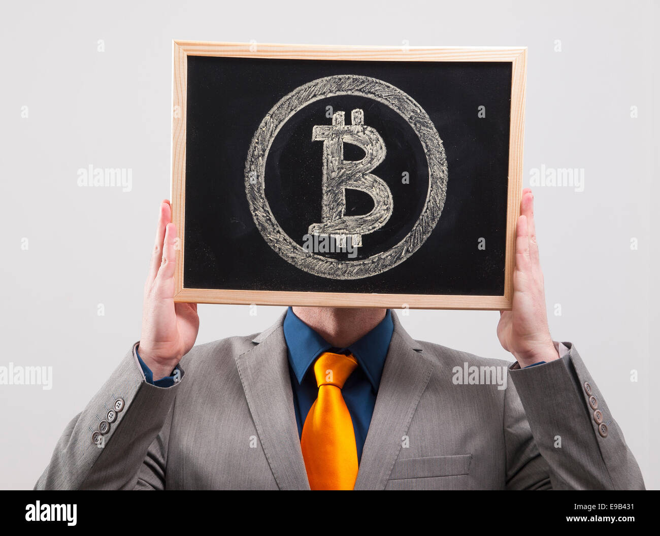 Businessman hiding his face behind bitcoin symbol and isolated on grey ...